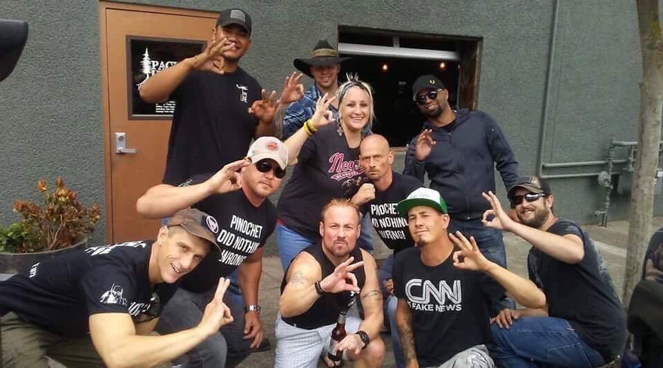 Is that an OK sign? A white power symbol? Or just a right-wing troll?